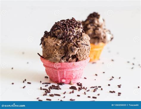 Ice Cream In Small Pink Wafer Cup On White With Chocolate Sprinkles