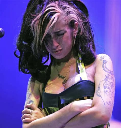 Amy Winehouse Crying And Hugging Herself As She Is Booed By Fans During
