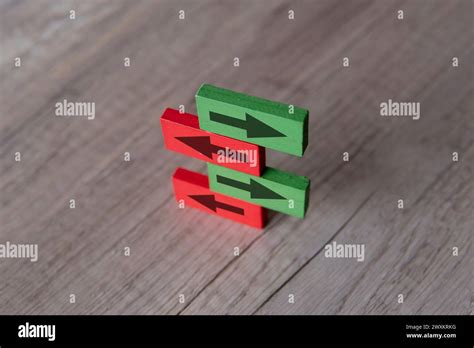 A Stack Of Wooden Blocks With Arrows Are Pointing In Opposite