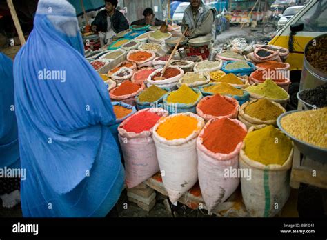 Women in burqas shopping for spices in a local market, Kabul Stock ...