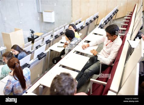 Group Of Students With Notebooks In Lecture Hall Stock Photo Alamy