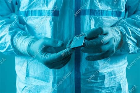 A Man In Sterile Form Holds A Microprocessor Close Up Microchip