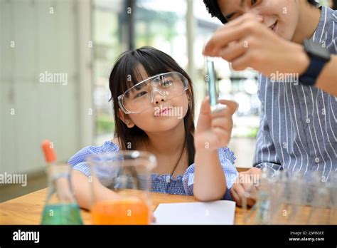Smiling Cute Young Asian Girl With Science Goggles Learning And Doing