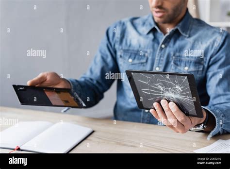 Cropped View Of Businessman Disassembling Digital Tablet And Holding