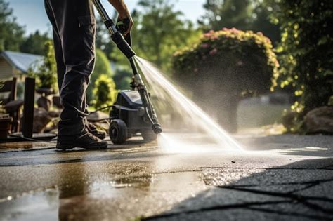 Premium Ai Image A Man Uses A Power Washer To Thoroughly Clean A