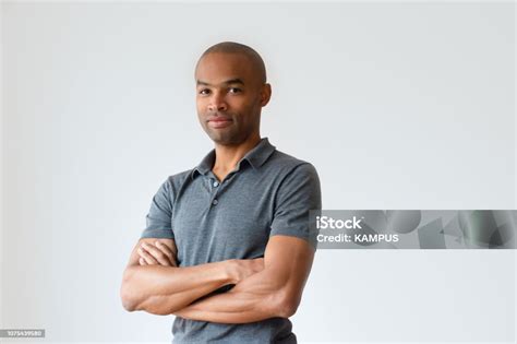 Successful Bald African American Man Standing With Crossed Arms Stock