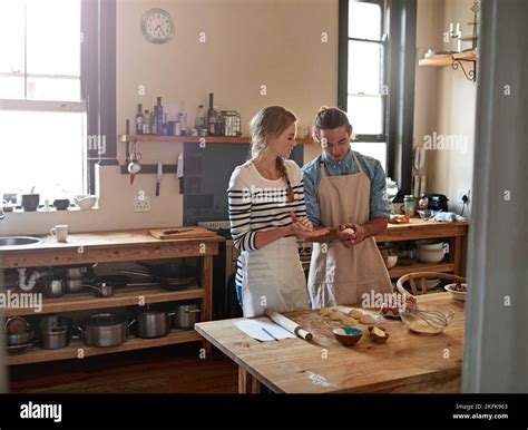 Baking Is Love Made Edible A Young Couple Making Small Balls Of Dough