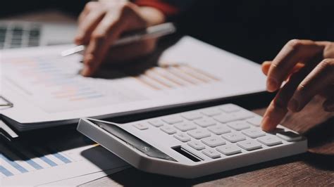 Businessmen Are Calculating Income Expenditure And Analyzing Real