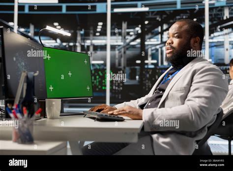 Data Center Technician Inspecting Gear Using Green Screen Mockup Pc