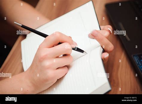 Closeup Of A Female Hand Writing On An Blank Notebook With A Pen Stock Photo Alamy