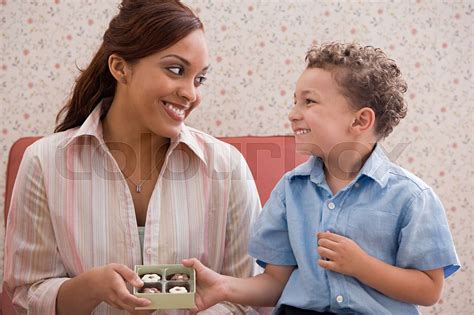 Son Giving Chocolates To Mother Stock Image Colourbox