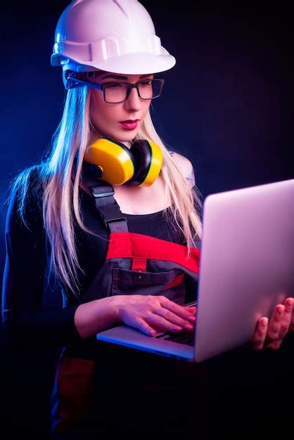 Premium Photo The Sexy Female Architect With A Laptop In Glasses In The Neon Light