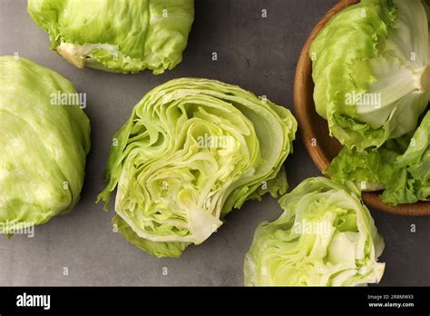 Fresh Green Cut And Whole Iceberg Lettuce Heads On Grey Table Flat Lay