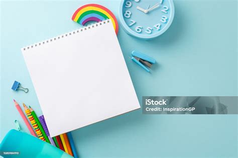 빈 앨범 페이지와 파스텔 블루의 고립된 배경에 있는 다채로운 문구류의 매혹적인 오버헤드 샷으로 학습자에게 영감을 줍니다 이 이미지로 교육 콘텐츠와 광고를 향상시키세요 0명에