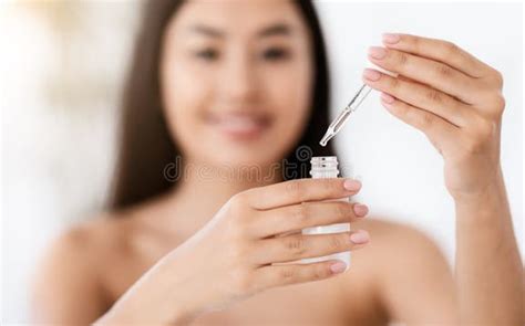 Bottle With Face Serum In Young Asian Woman Hands Stock Image Image Of Cream Joyful 370689185