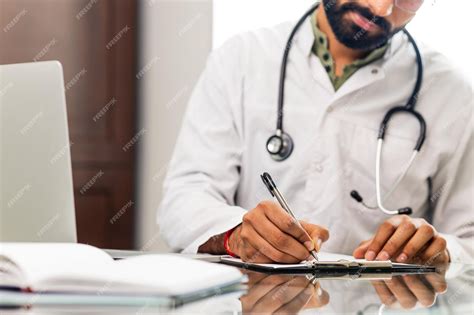 Premium Photo Indian Doctor Wearing Uniform Taking Notes In Medical