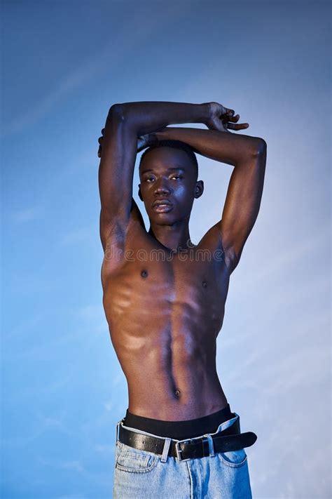 Two Shirtless Men Engaging In An Intense Outdoor Tug Of War Competition