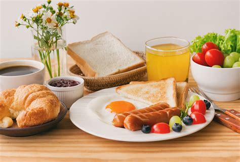 계란 토스트 소시지 과일 야채 딸기 잼 측면 보기 복사 공간에에서 오렌지 주스를 햇볕이 잘 드는 측면 함께 홈메이드 아침 식사