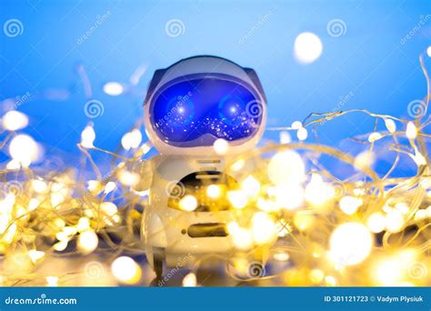 Spread And Development Artificial Intelligence In New Year Small Real Robot With Garlands On