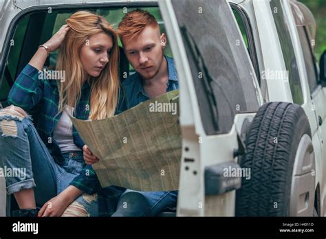 Couple Analyzing Map While Sitting In Off Road Vehicle At Forest Stock Photo Alamy