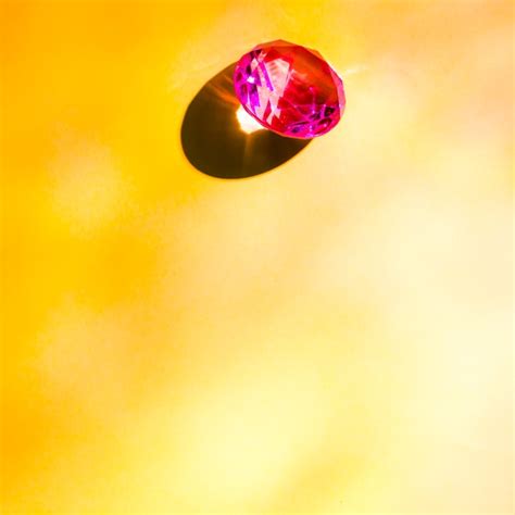 Premium Photo Realistic Shiny Ruby With Dark Shadow On Yellow Background