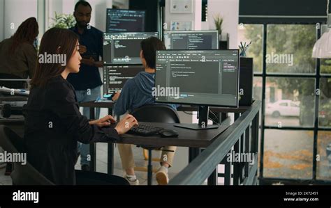 Asian Software Engineer Working With User Interface On Computer Screen