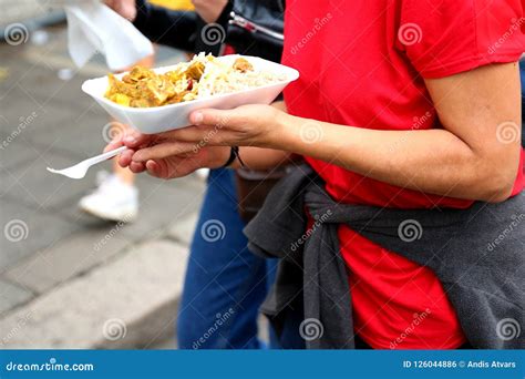 Hands Holding Street Food Dish A Street Food Market Selective Focus