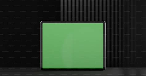 검은색 배경에 녹색 화면이 있는 태블릿 사진 Unsplash의 아이패드 모형 이미지