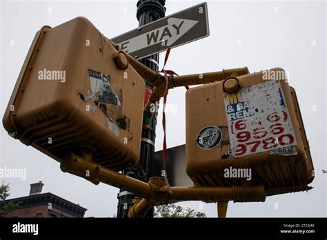 A Traffic Light With Multiple Colorful Stickers Adorning The Front Of