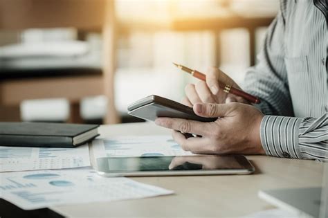 Premium Photo Businessman Calculation And Holding Calculator Analysis Summary Report With Tablet