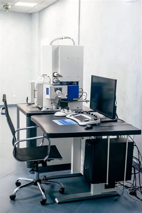 Work Space Of A Scientist With Electron Microscope Table And Computer