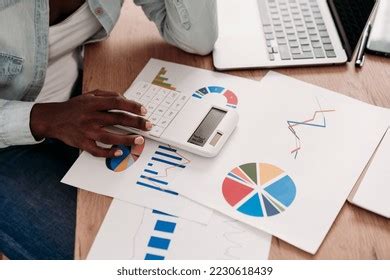 Businesswoman Using Calculator Diagrams On Desk Stock Photo Shutterstock