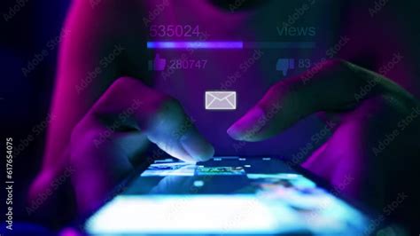 Woman Touching Scroll Page App On Mobile Phone In A Room With Blue And Purple Neon Tones Concept