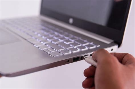 Premium Photo Usb Plugged Into The Laptop For Data Transfer With Hand