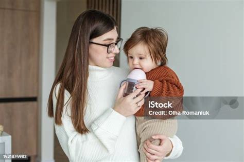 유아 소녀는 어머니의 조심스러운 눈 아래 누출 방지 병에서 물을 마신다 마시기에 대한 스톡 사진 및 기타 이미지 마시기 아기 어머니 Istock