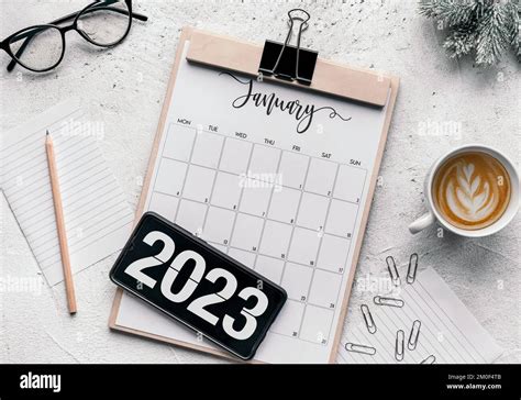 Top View Of Notepad With January 2023 Calendar On Table Number 2023 On