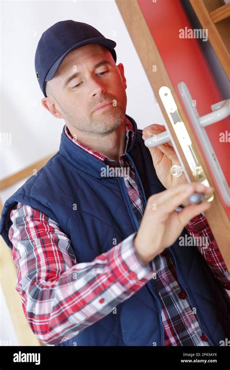 Man Fixing A Door Lock Stock Photo Alamy