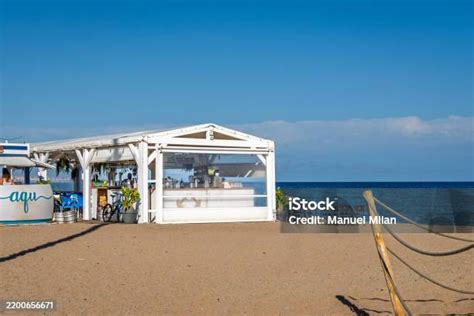 모래 해변의 맑고 푸른 하늘 아래 흰색 목조 건물 좌석 바다 전망이 있는 해변 바 겸 레스토랑입니다 0명에 대한 스톡 사진 및 기타 이미지 Istock