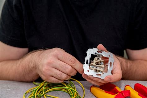 Premium Photo Electrician Repairing A Socket