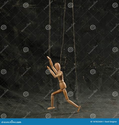 Puppet In The Hands Of Puppeteer Walks On Isolated Background The Concept Of Manipulation