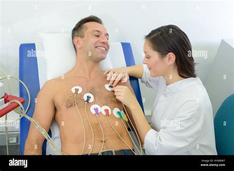 Nurse Attaching Heart Monitor Pads To Patient Stock Photo Alamy