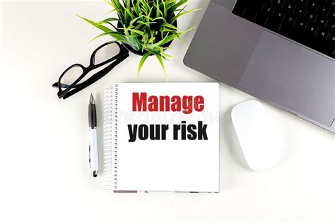 Manage Your Risk Text On Notebook With Laptop Mouse And Pen Stock