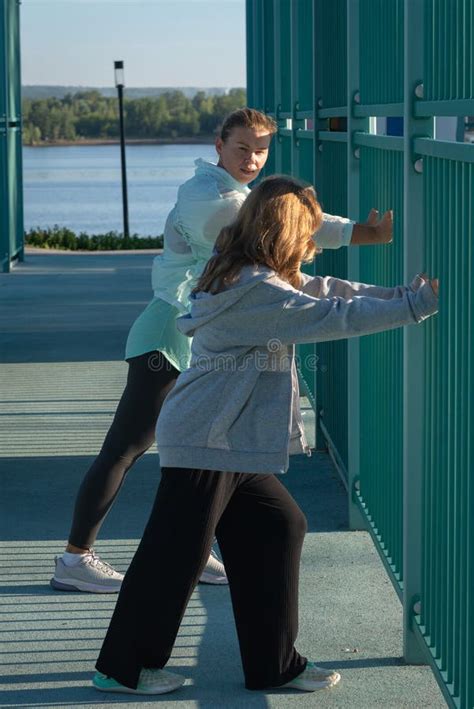 Mom And Babe Doing Exercises Together At City Sports Ground Stock Photo Image Of
