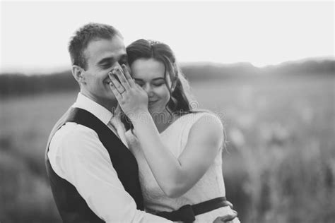 Happy Bride And Groom Hug Each Other In The Park At Sunset Wedding Stock Photo Image Of