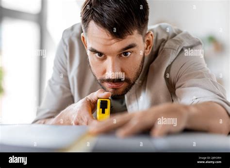Man With Ruler Measuring Table For Renovation Stock Photo Alamy