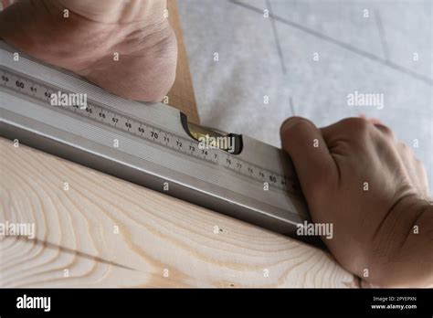 Close Up Cropped Male Worker Hands Hold Water Pass Level For Building