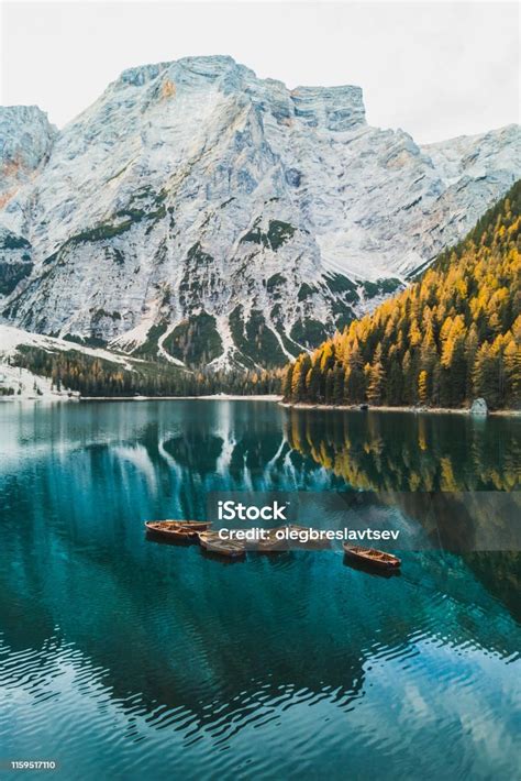 이탈리아 북부 돌로미티 산맥의 라고 디 브레이스 호수의 가을 풍경 나무 보트와 일출에 잔잔한 물에 아름다운 반사와 무인 항공기 공중 사진 프라저 와일드제 0명에 대한 스톡