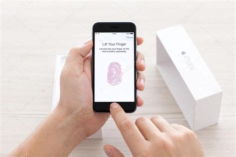 Man Scans The Fingerprint Sensor Touch Id On Iphone 6 Stock Editorial