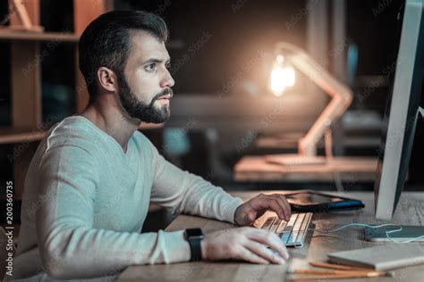Typical Programmer Pensive Serious It Guy Sitting In Profile While Using Computer And Coding
