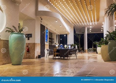 Modern Hotel Lobby With Decorative Pots And Ambient Lighting At Night